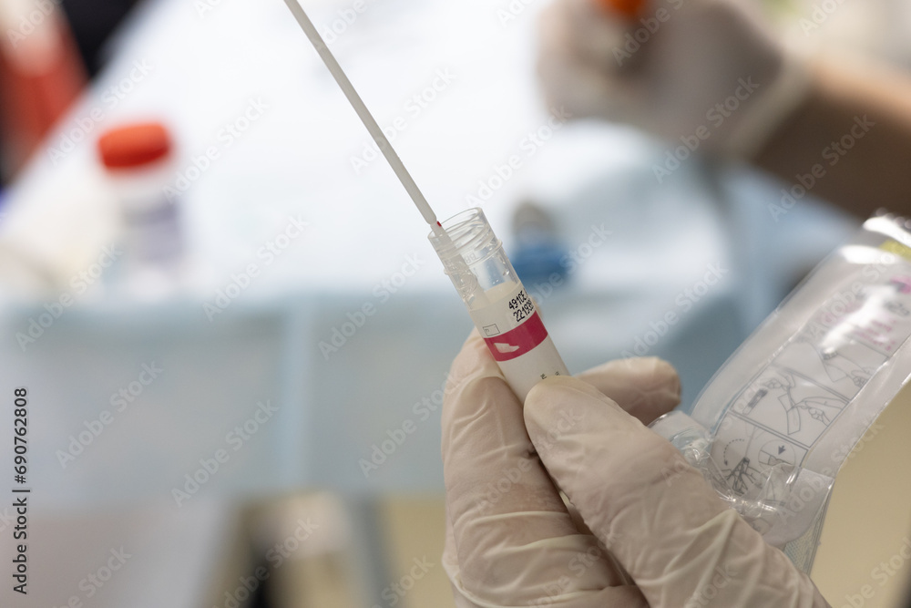 Fotografia do Stock: The doctor removes a piece of tissue from the ...