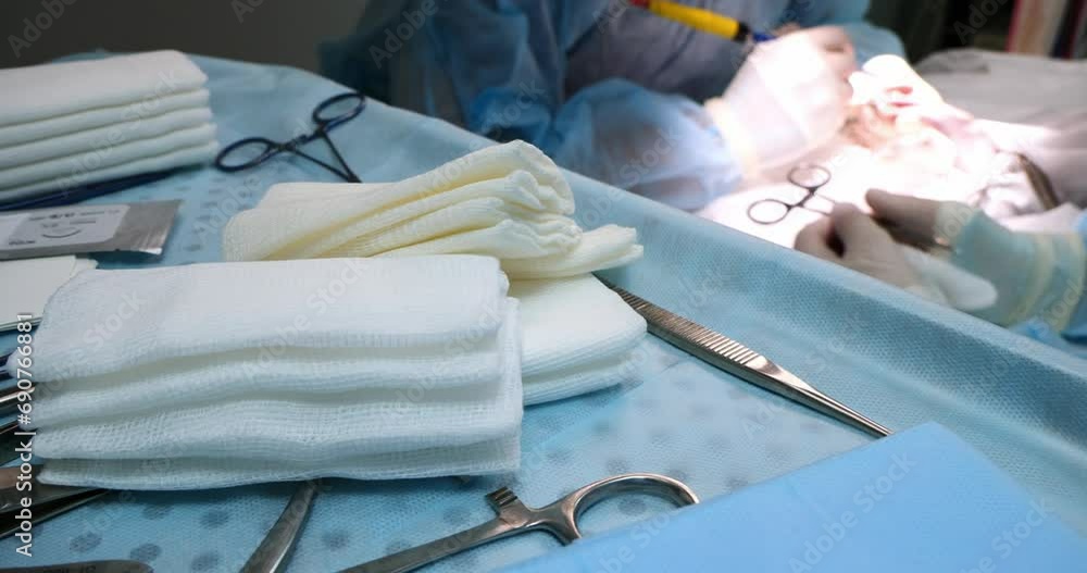 The surgical instrument is neatly laid out on the operating room table ...