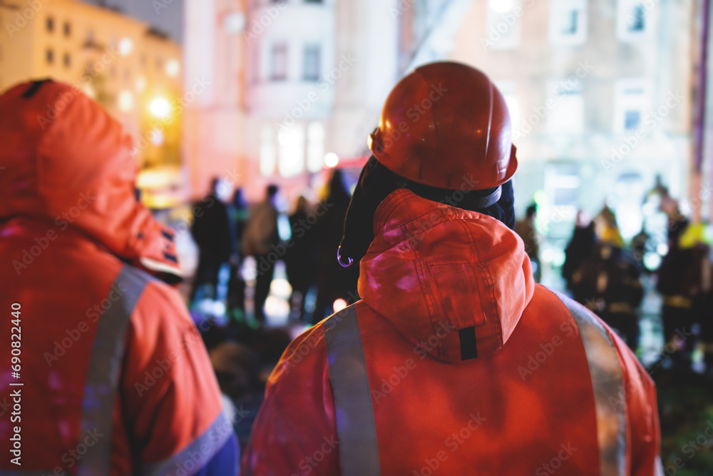 Group of fire men in protective uniform during fire fighting operation ...
