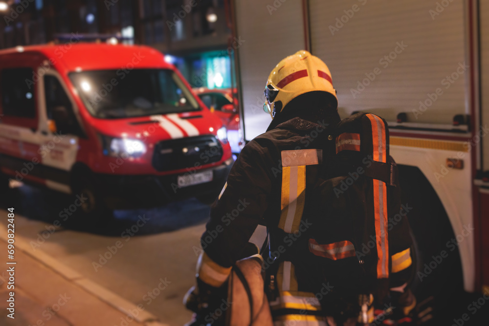 Group of fire men in protective uniform during fire fighting operation ...