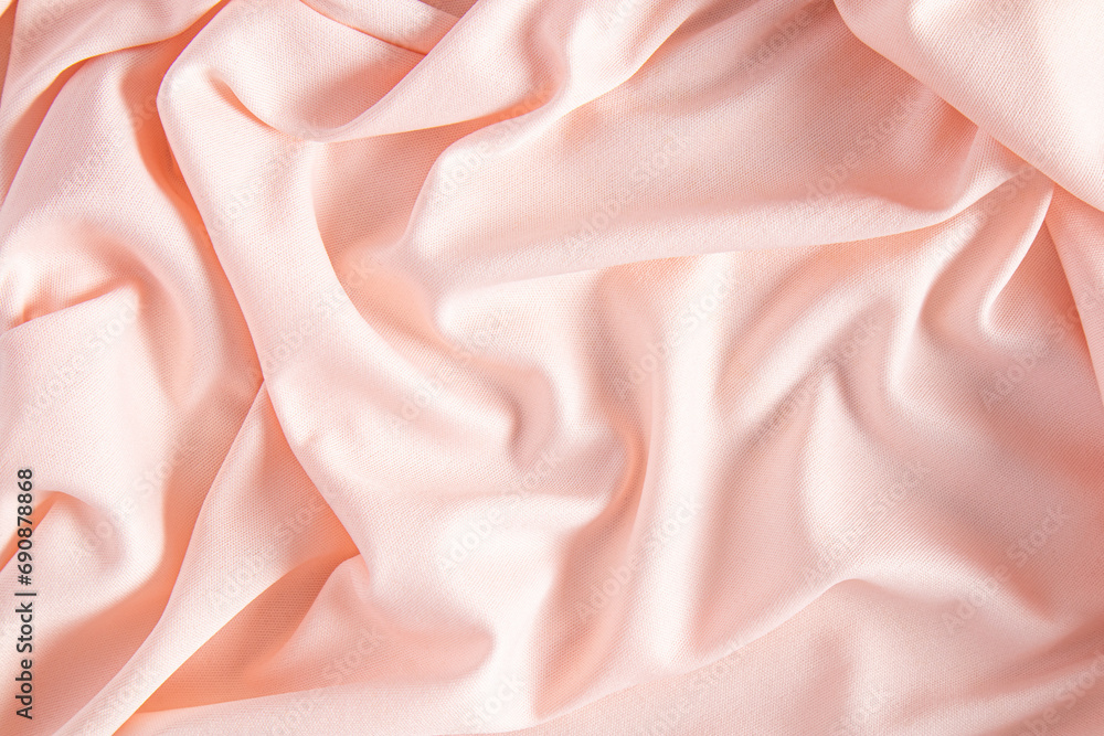 Luxurious satin textiles in peach color. Soft abstract waves of factory ...