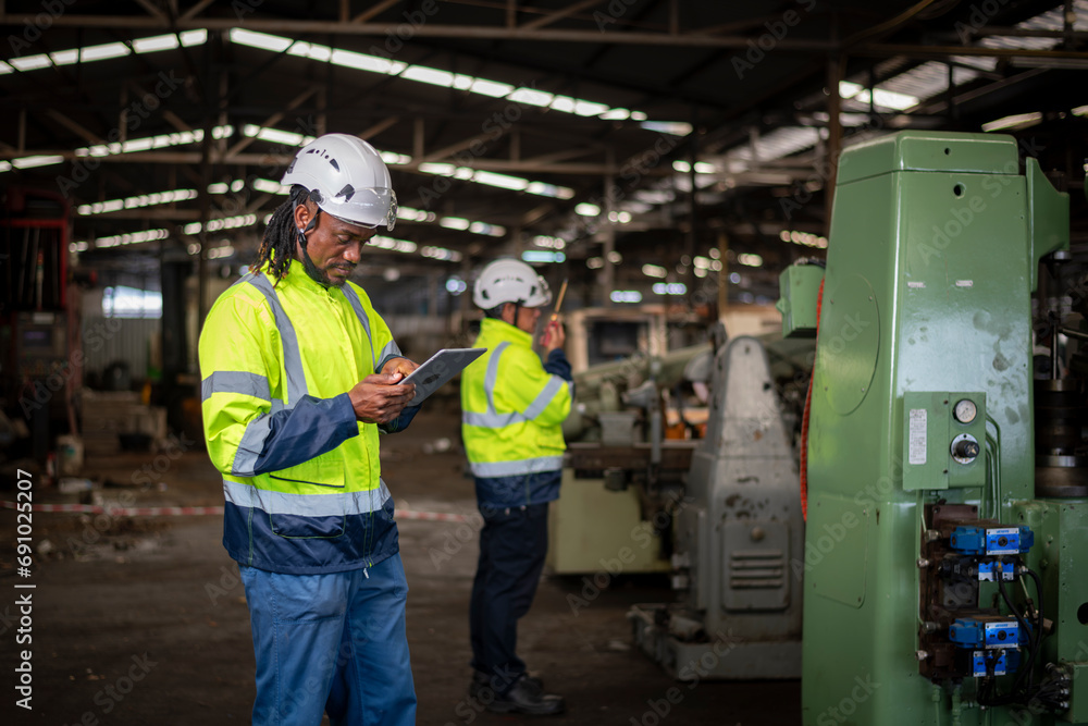 Engineer worker wearing safety uniform control operating and check controlled Lathe grinding ...