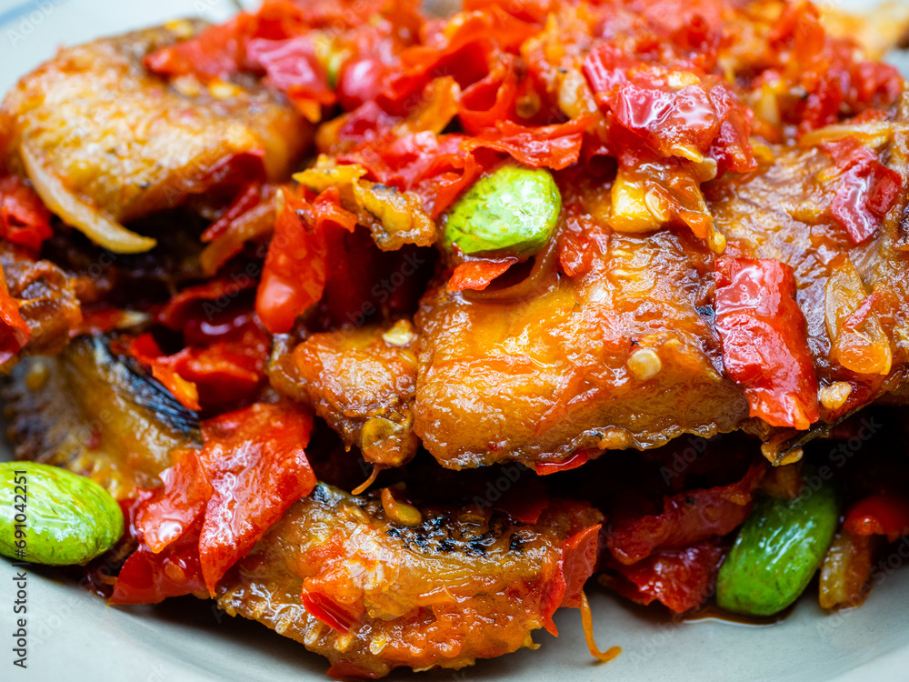 Fried salted snakehead fish with balado and petai sauce. Stock Photo ...