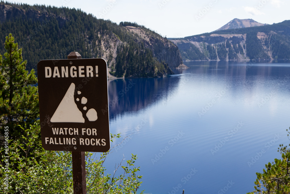 Danger Watch for Falling Rocks sign overlooking Crater Lake in Crater ...