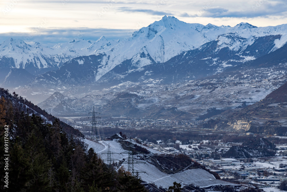 swiss mountains in the winter, the Rhone valley with the city of Sion ...