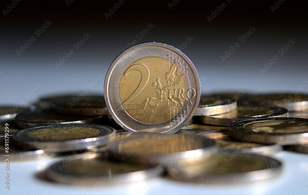 2 euro coin standing on the edge and facing the viewer with its face ...