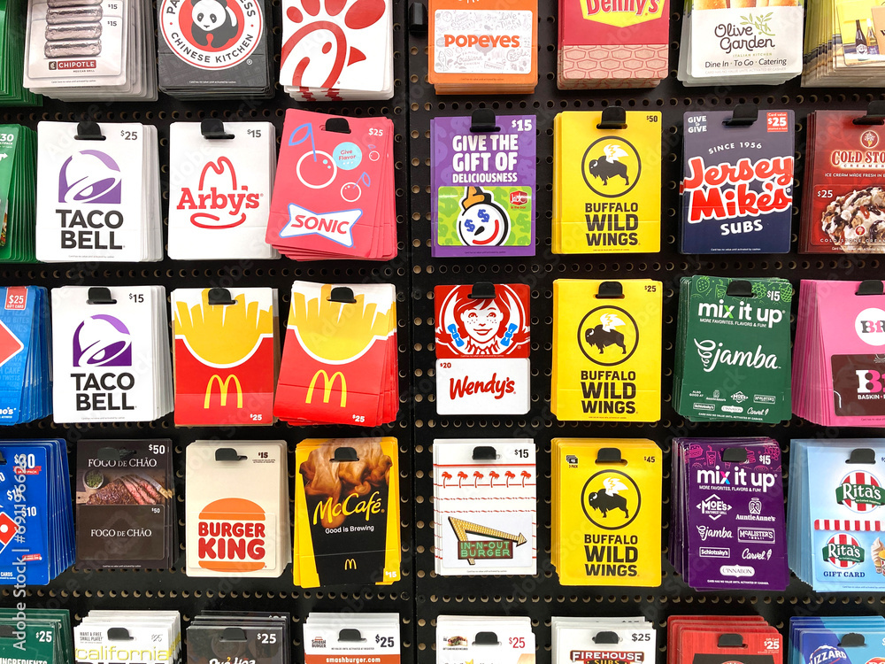 Fast food and restaurant gift cards displayed on stand. Including Panda ...
