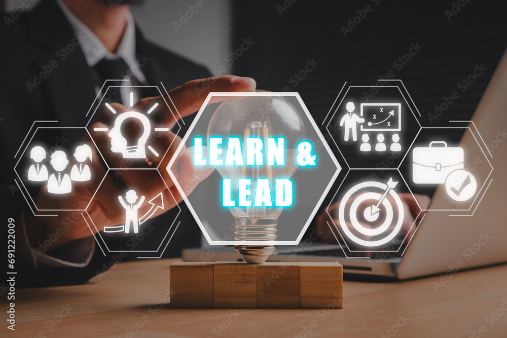 Learn and Lead concept, Businessman hand holding lightblub on office ...