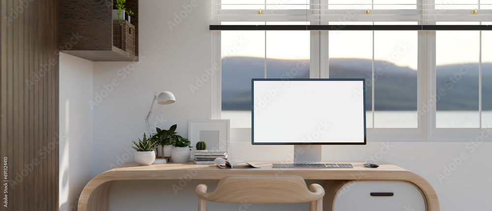 PC computer white screen mockup on a modern wooden desk against the ...