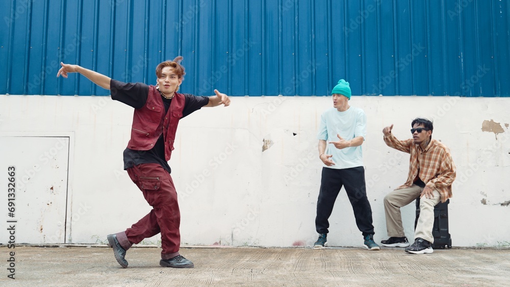 Young street dancer dancing in hip hop style with multicultural friends ...