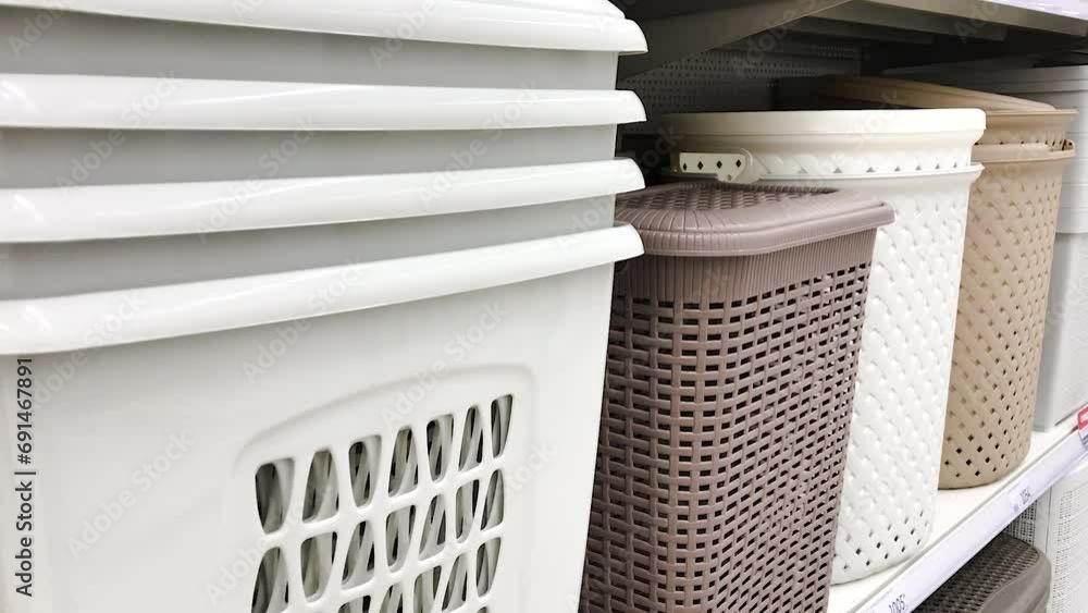 Laundry baskets in store . Collection of dirty laundry white plastic ...