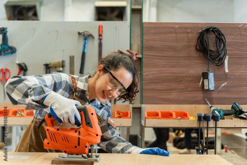Carpenter woman one smile young aged standing aim working on wood plank ...