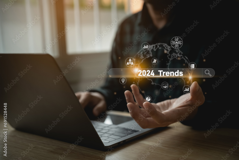 Trends 2024 year concept. Man holding earth using laptop and showing ...