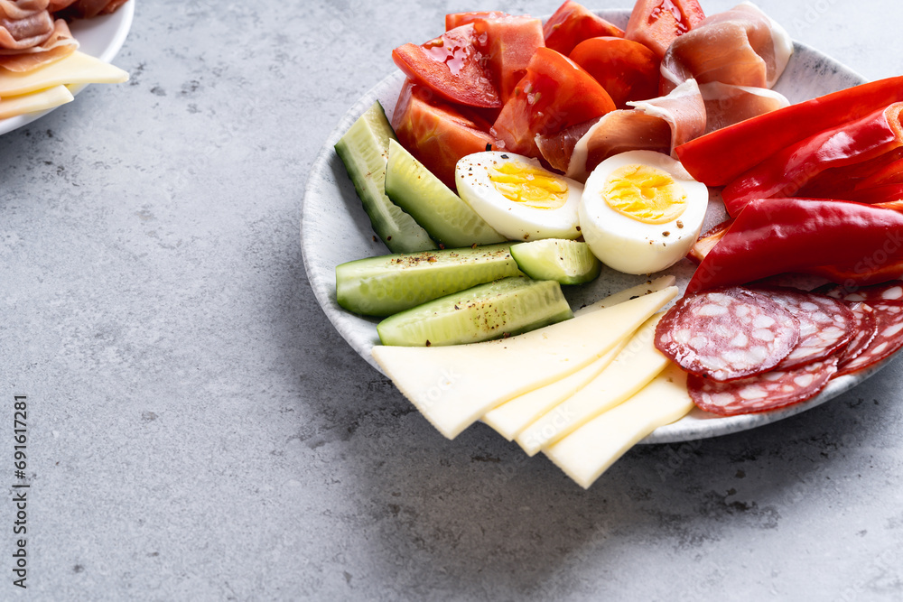 Healthy snack plate with cheese, meat, vegetables, boiled egg ...