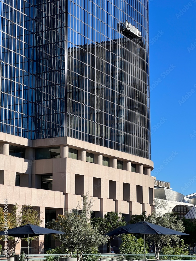 LOS ANGELES, CA, OCT 5, 2023: window cleaners working from a platform ...