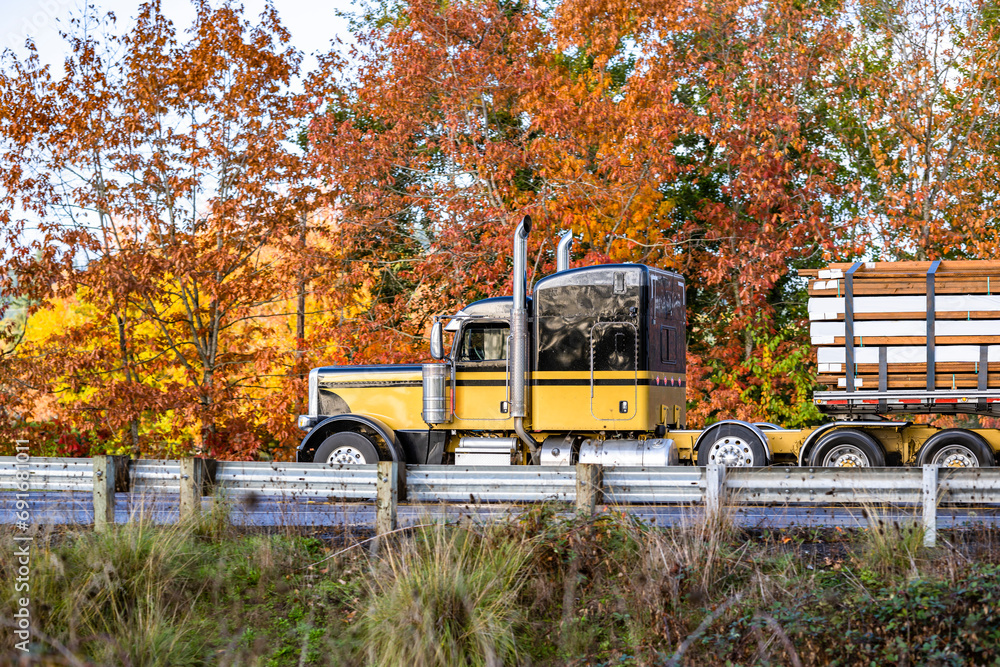 Beige and black classic big rig semi truck with low profile extended ...