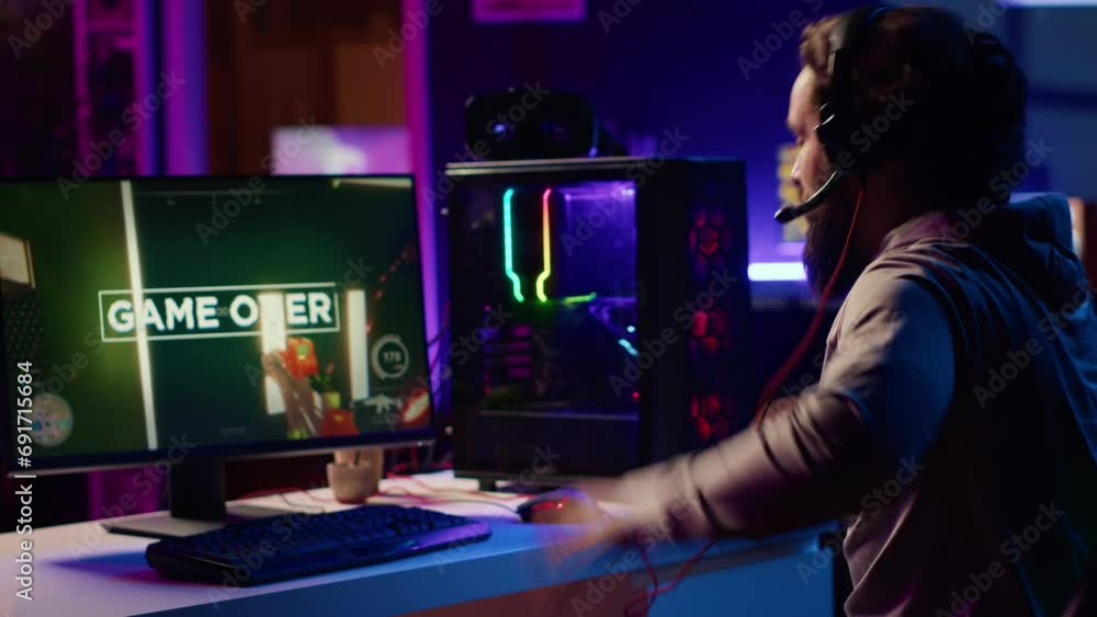 Gamer throwing headphones in frustration after receiving game over ...