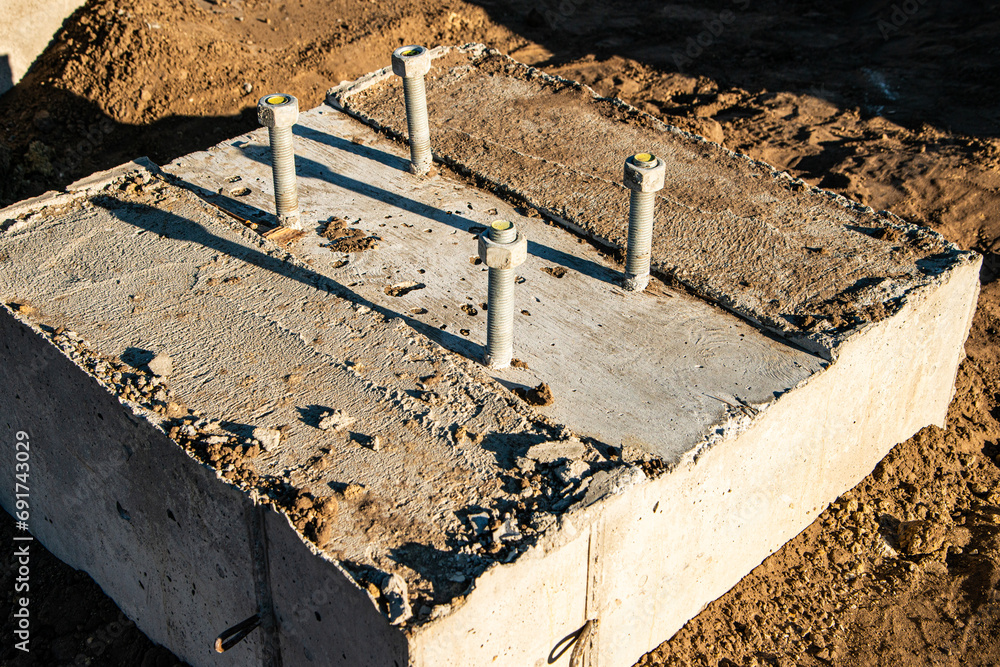 Concrete footings with anchor bolts ready for framing of new commercial ...