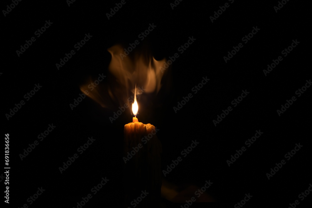 Candle flame with exploding flammable liquid sprayed onto flame ...