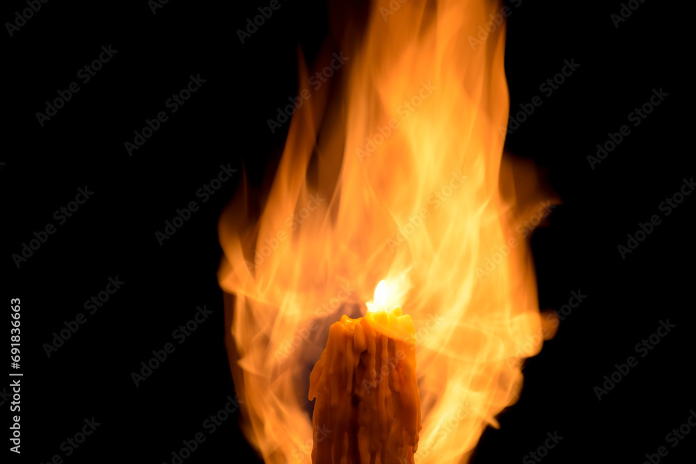 Candle flame with exploding flammable liquid sprayed onto flame ...