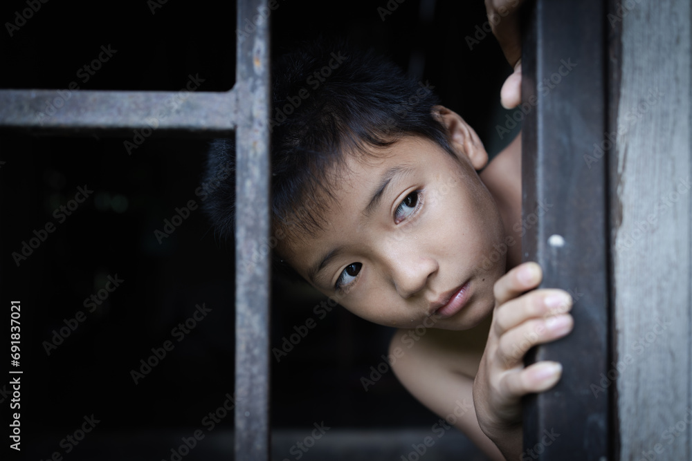 The child captured the iron cage with sadness and despair. The concept ...