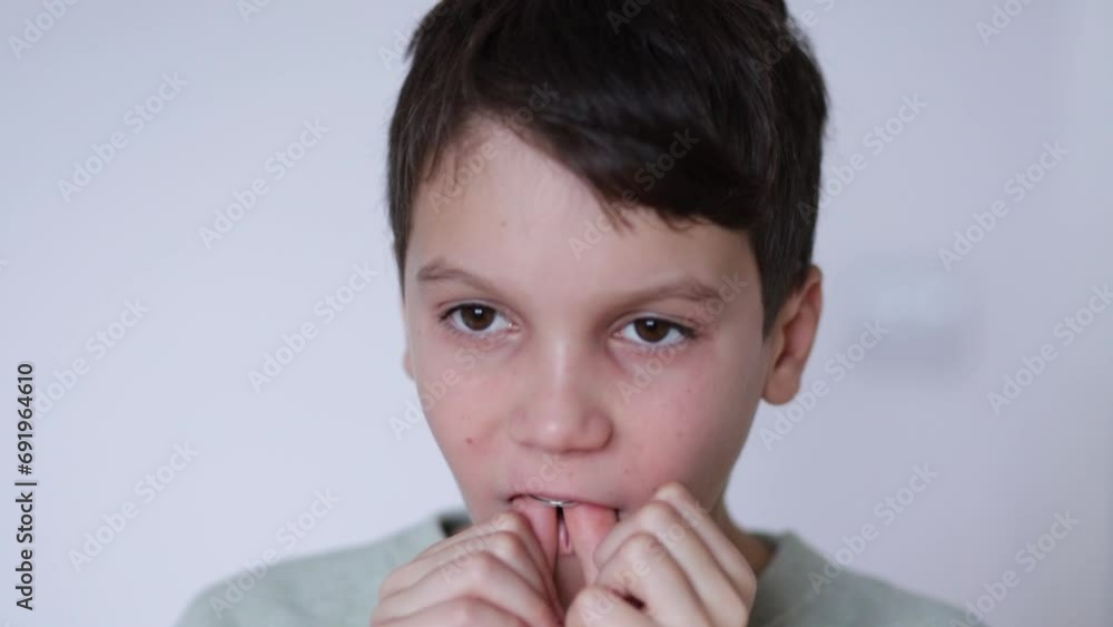 A boy puts on retainers, on a white background. Concept of correcting ...