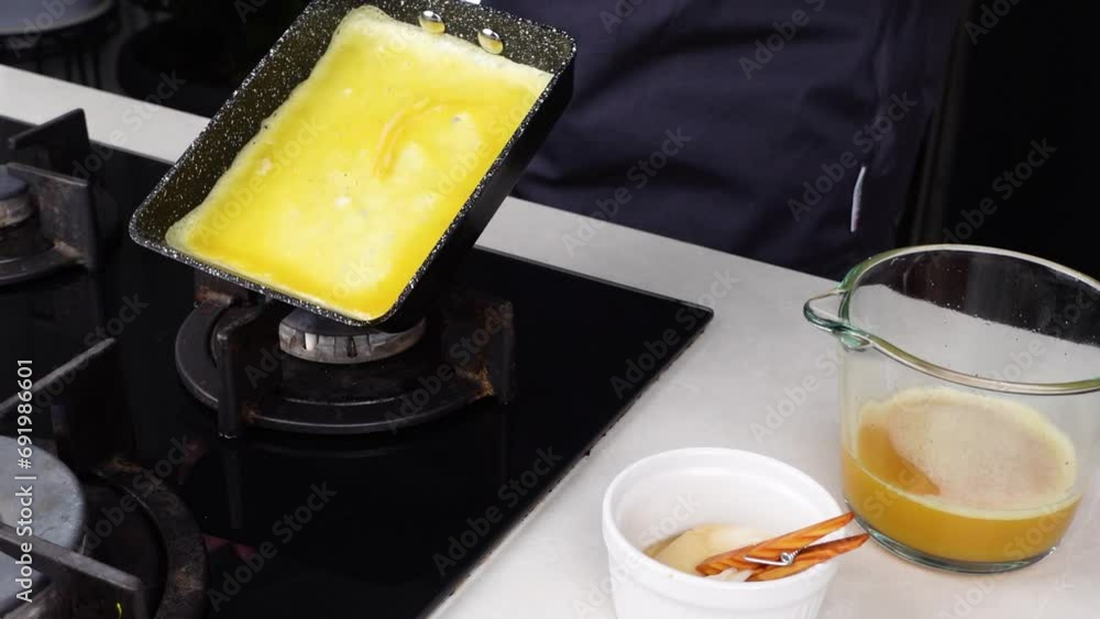 Chef man hands cooking Tamagoyaki or Tamago traditional Japanese Rolled ...