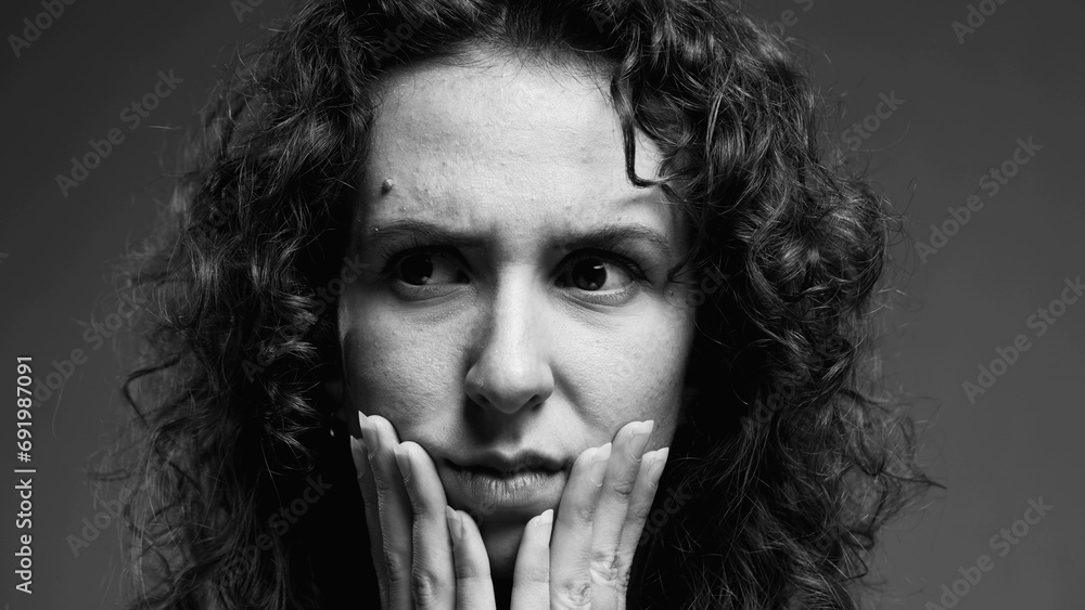 Preoccupied pensive woman contemplating difficult decision in black and ...