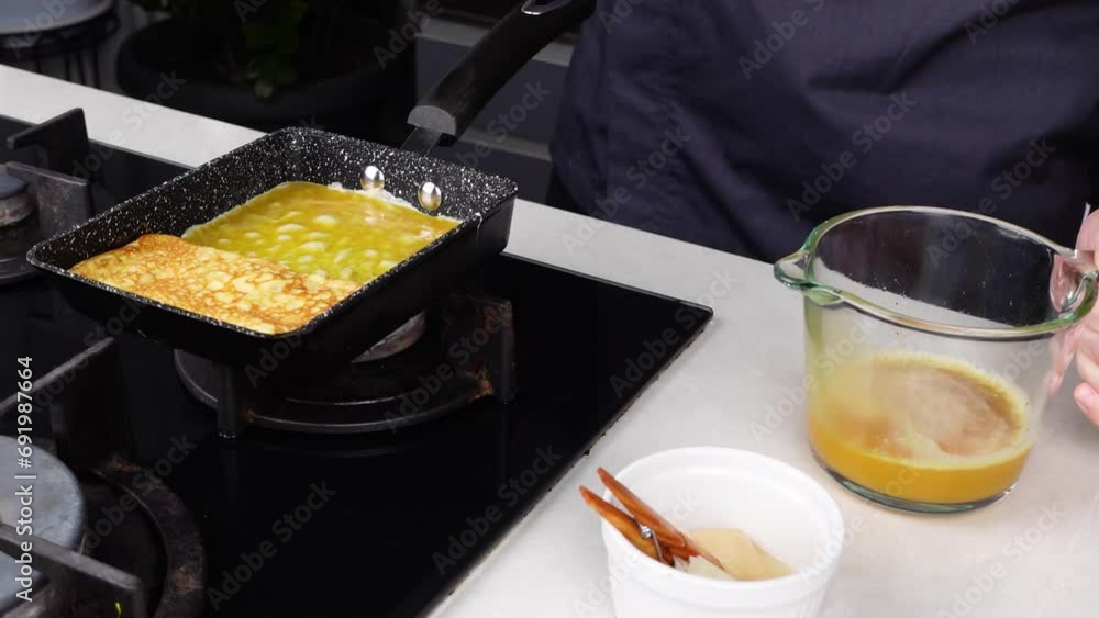 Chef man hands cooking Tamagoyaki or Tamago traditional Japanese Rolled ...