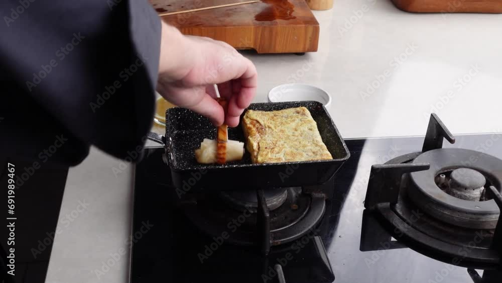 Chef man hands cooking Tamagoyaki or Tamago traditional Japanese Rolled ...