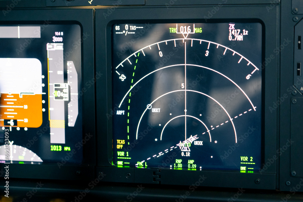 close-up of radar control and navigation panel in cockpit of airplane ...