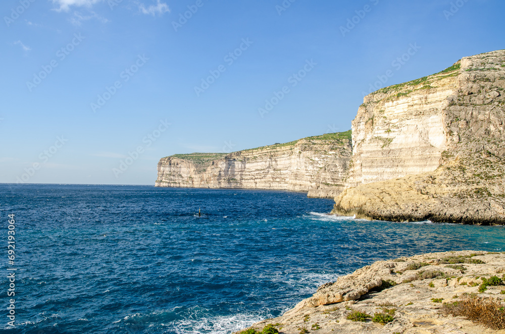 Rocky limestone coastline of Gozo island and Mediterranean Sea with ...