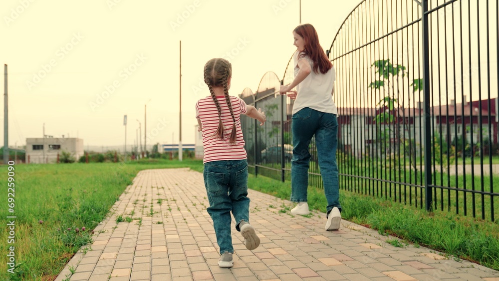 Child, daughter plays with mom, run together in park. Happy family ...