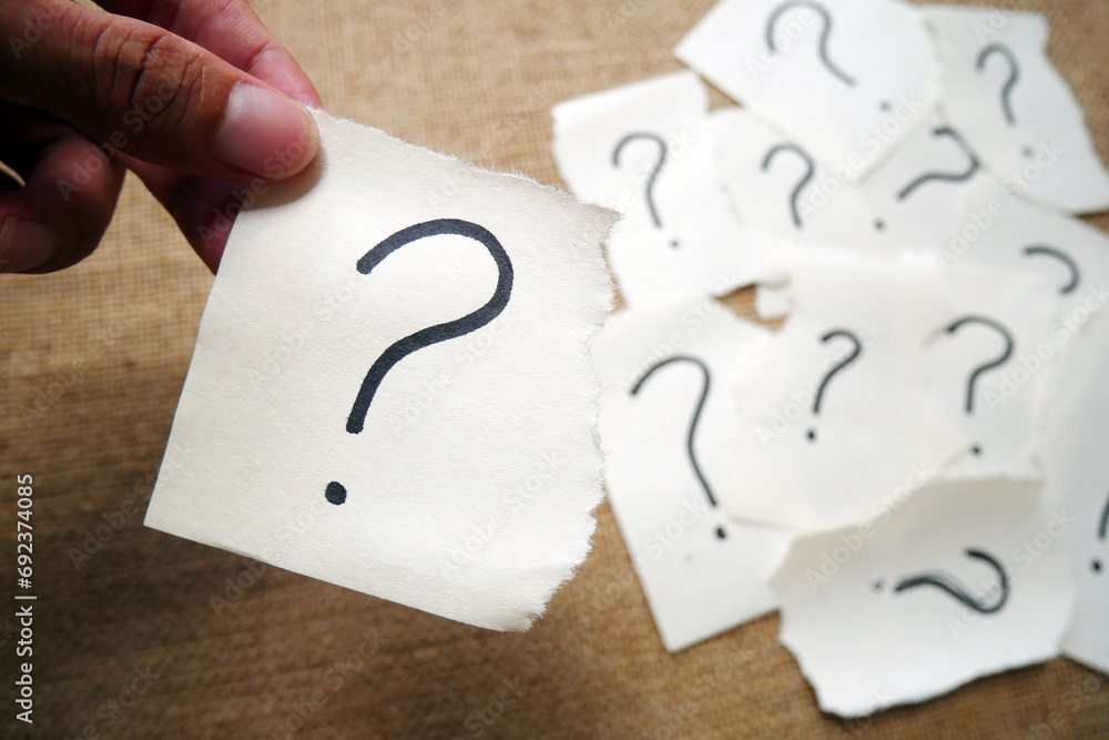 Question mark paper. Torn paper holding hand with question mark on ...