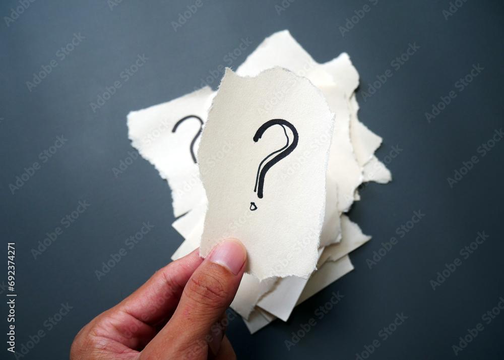 Question mark paper. Torn paper holding hand with question mark on ...