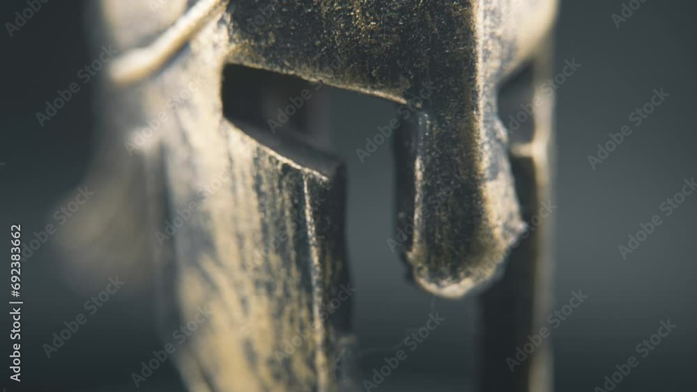 A close up macro detailed slow pan right shot of a spartan face design ...
