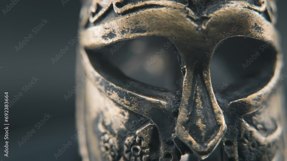 A close up macro professional slow pan right shot of a spartan face ...