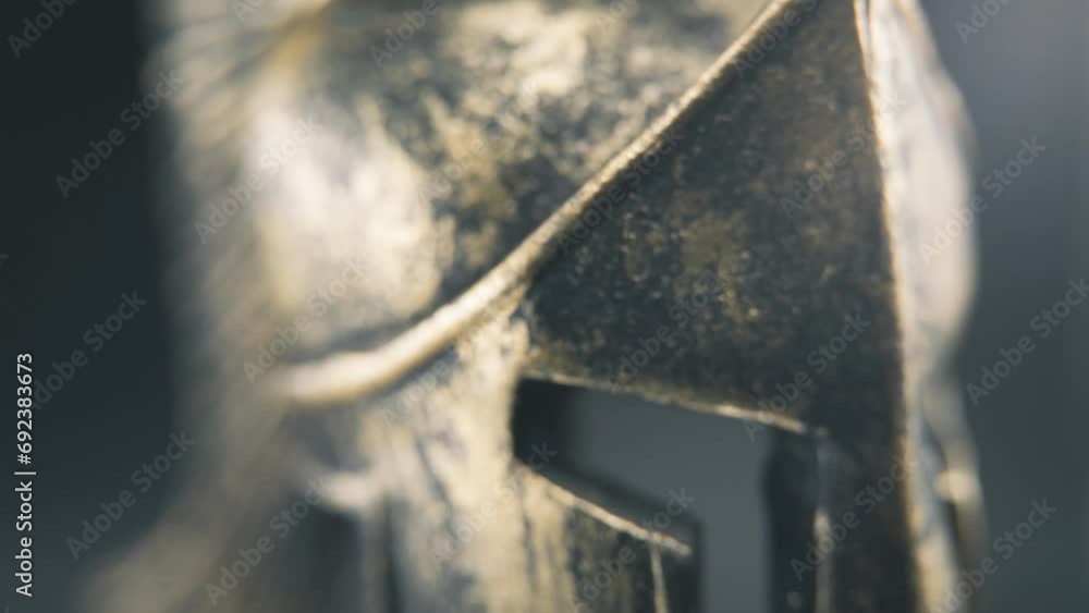 A close up macro spiral slow tilt up shot of a spartan face design ...