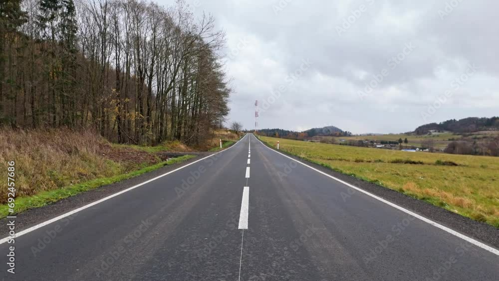 Smooth journey along a newly paved road, white lines guiding to a cell ...
