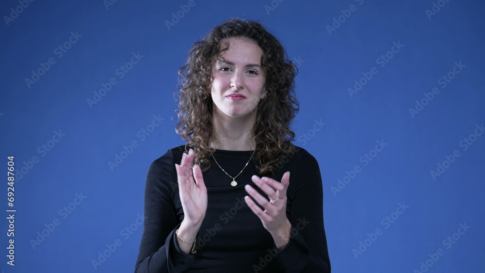 Woman congratulating herself by clapping hands and pointing at herself ...