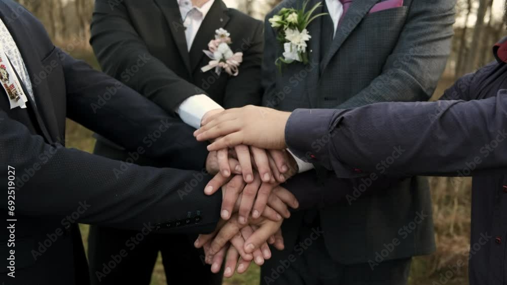 A group of men putting their hands together. A demonstration of unity ...