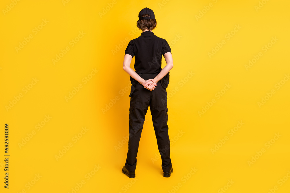 Full body rear photo of police girl standing hold hands behind back ...