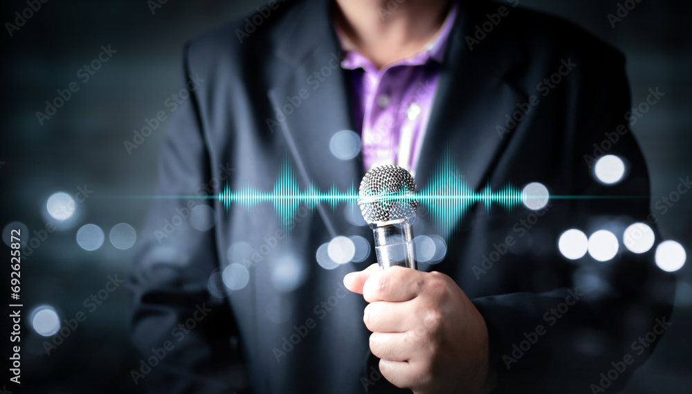 Man in business suit holding a microphone conducting a business ...