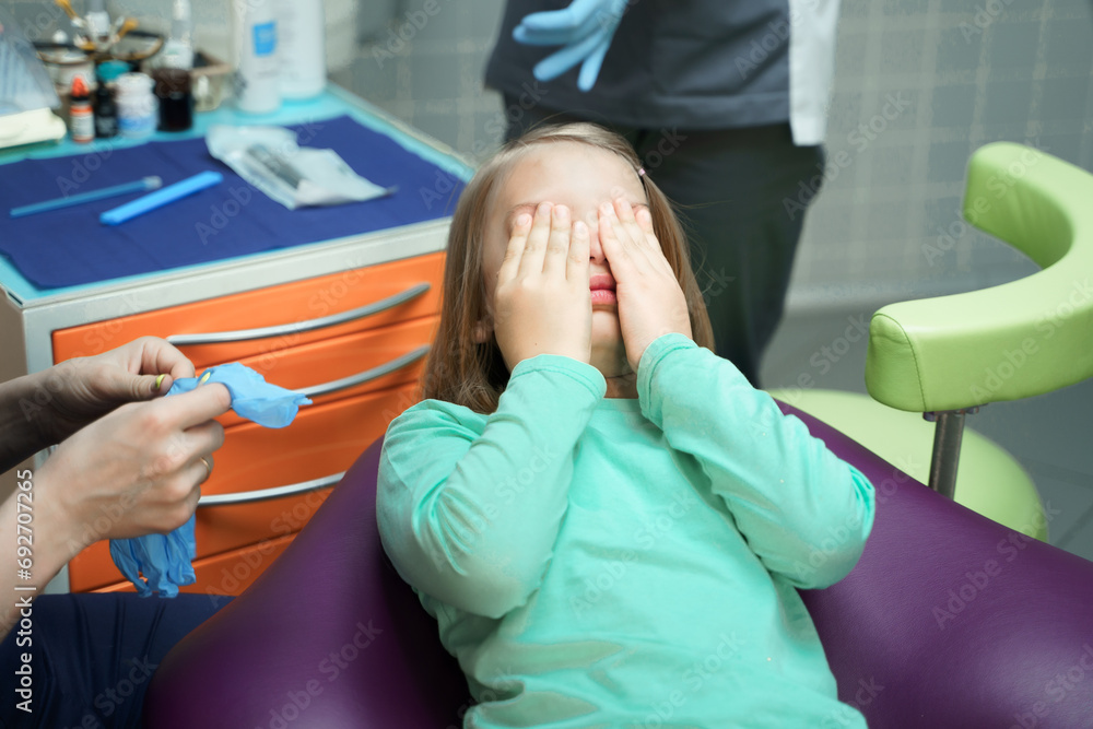 Little scared girl sitting in chair in dentist doctor office. Kid,child ...