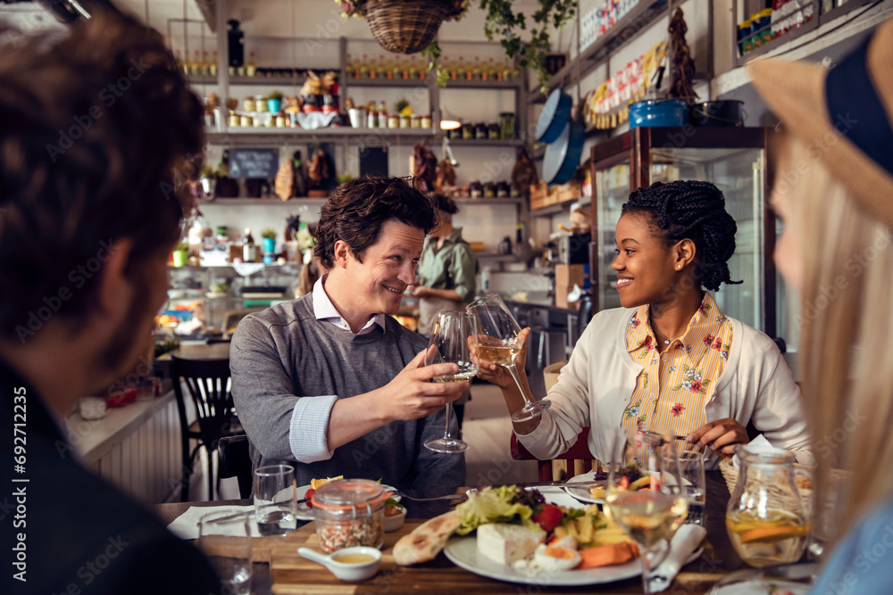 Happy friends talking and sharing a meal in the restaurant Stock Photo ...