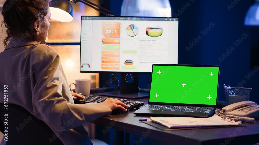 Business manager working with greenscreen on laptop, sitting at desk ...