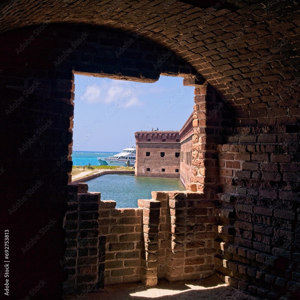 Window through brick scarp walls revealing moat and counterscarp ...