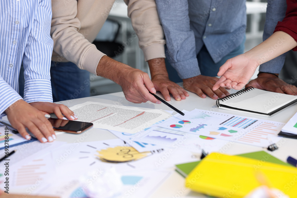 Team of employees working with charts at table, closeup. Startup ...