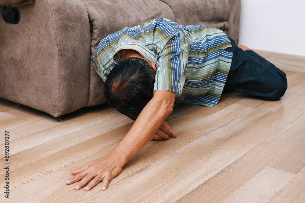 Elderly older grandfather having an accident, falling on the home floor ...