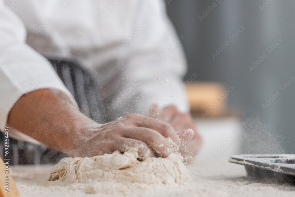 professional Chef sifting flour powder and sprinkling ingredients on ...